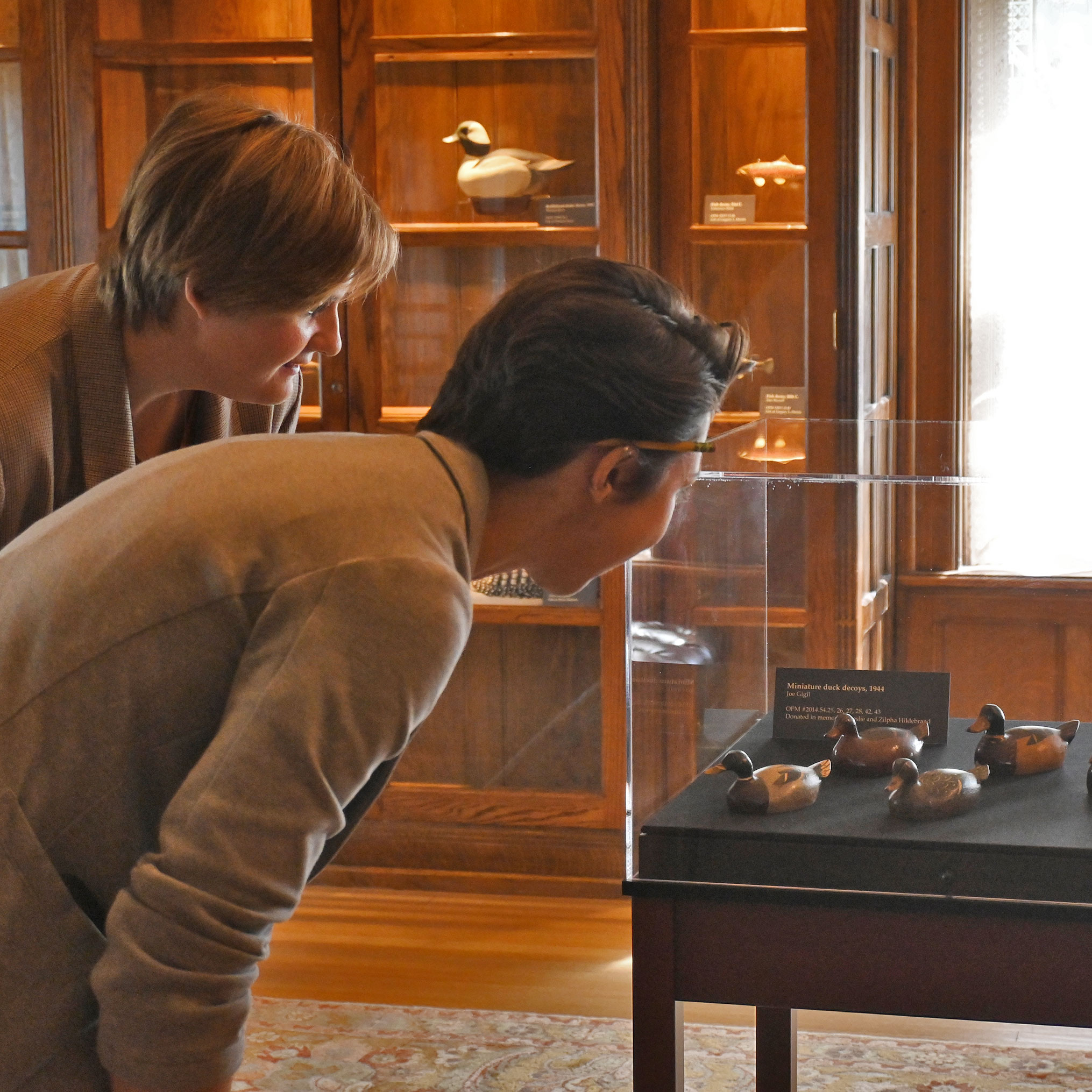 People inspecting Alluring Art decoys